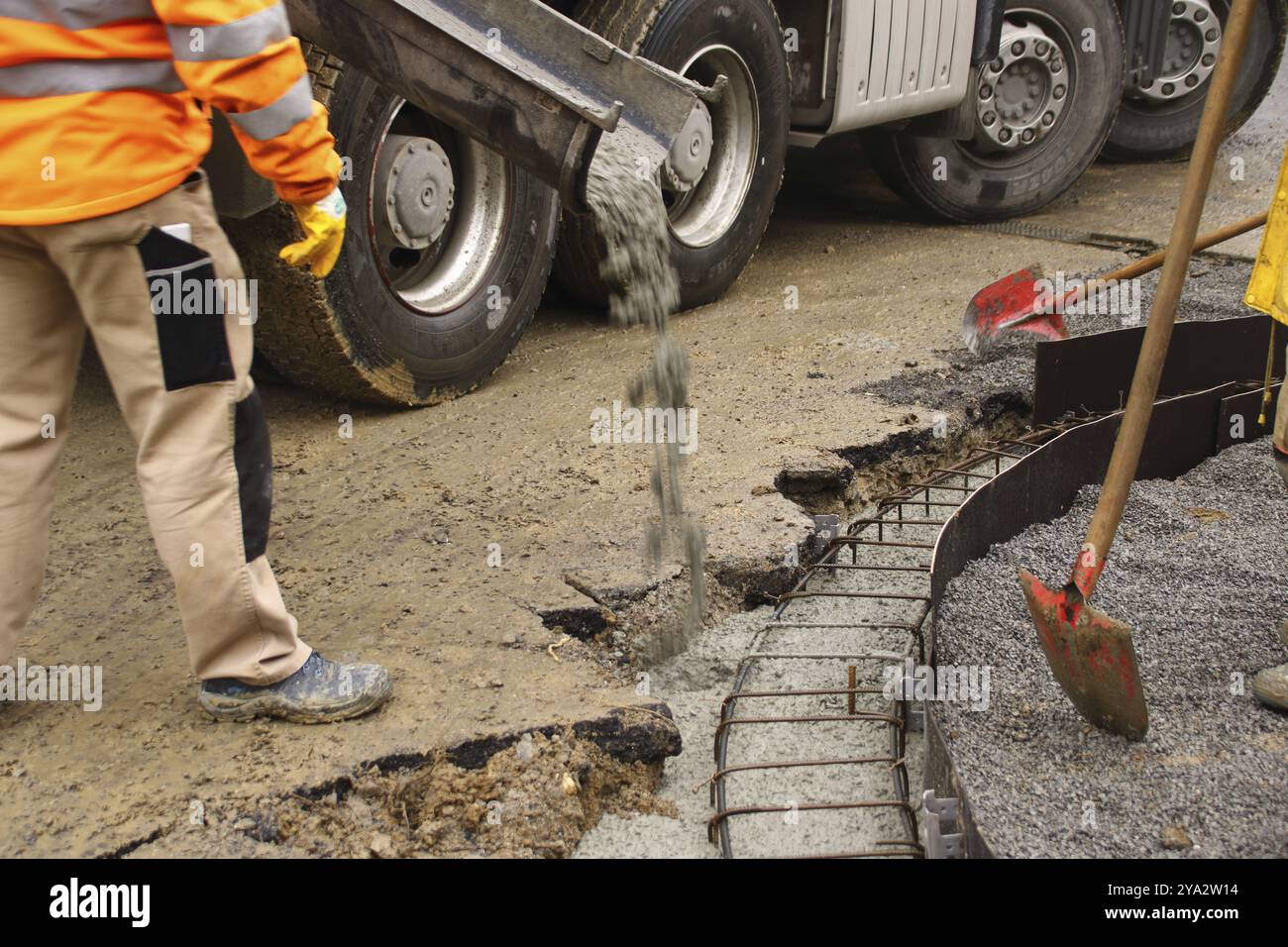 Filling a strip foundation with liquid concrete Stock Photo - Alamy