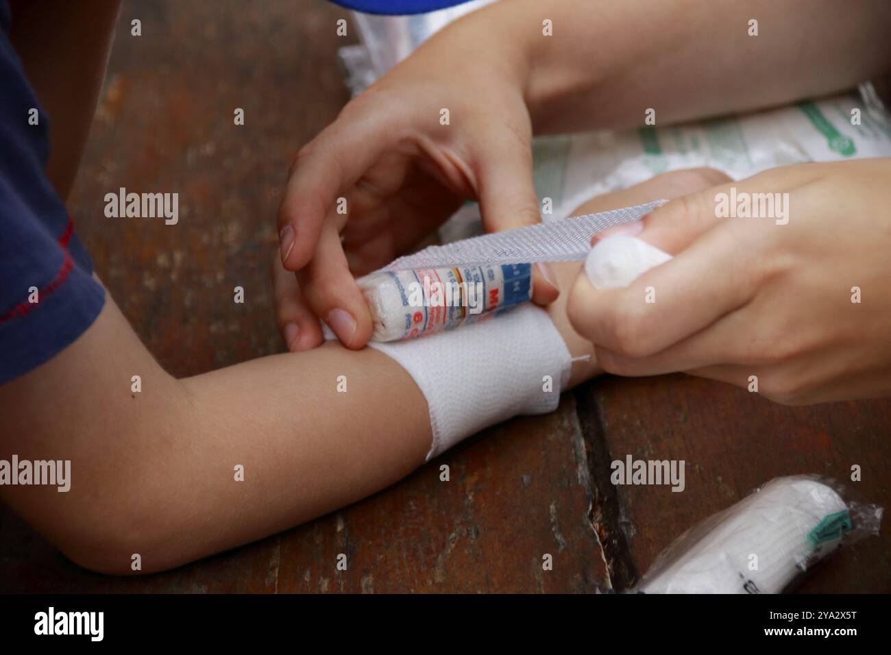 Applying a pressure bandage to a wound on a forearm Stock Photo - Alamy