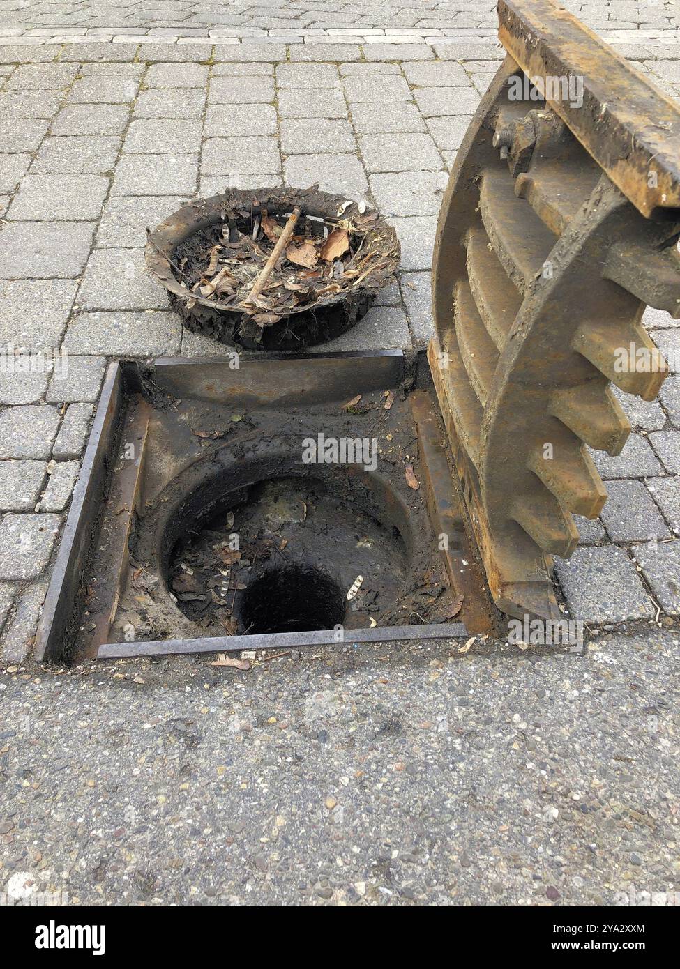 Inlet shaft for road drainage blocked by soil Stock Photo - Alamy