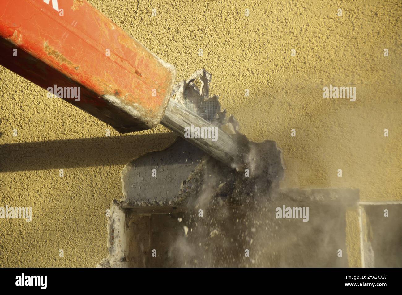 Demolition of a house wall with a large chisel Stock Photo - Alamy