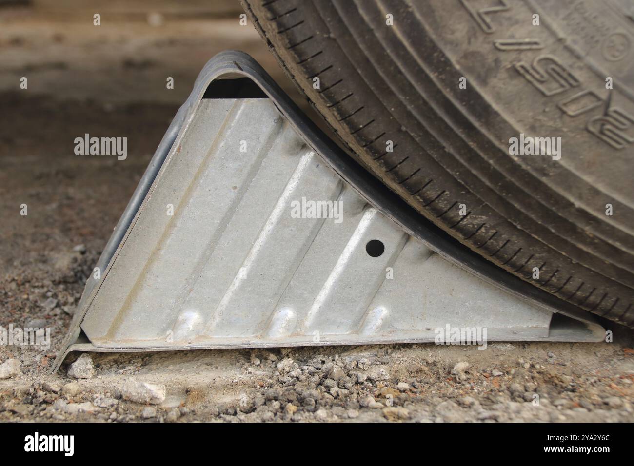 Trailer is secured against rolling away with a wedge Stock Photo - Alamy