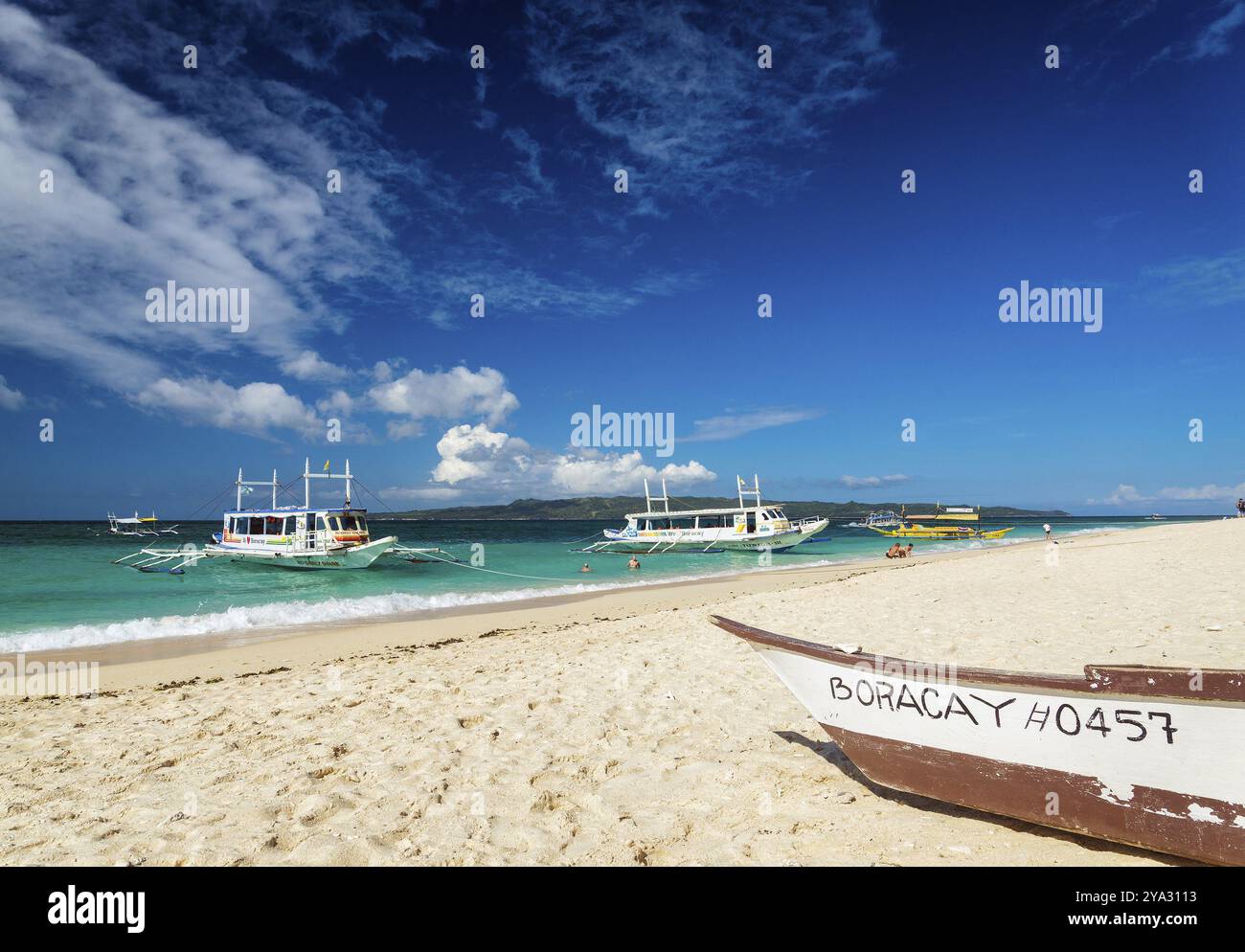 Traditional filipino asian ferry taxi tour boats on puka beach in ...