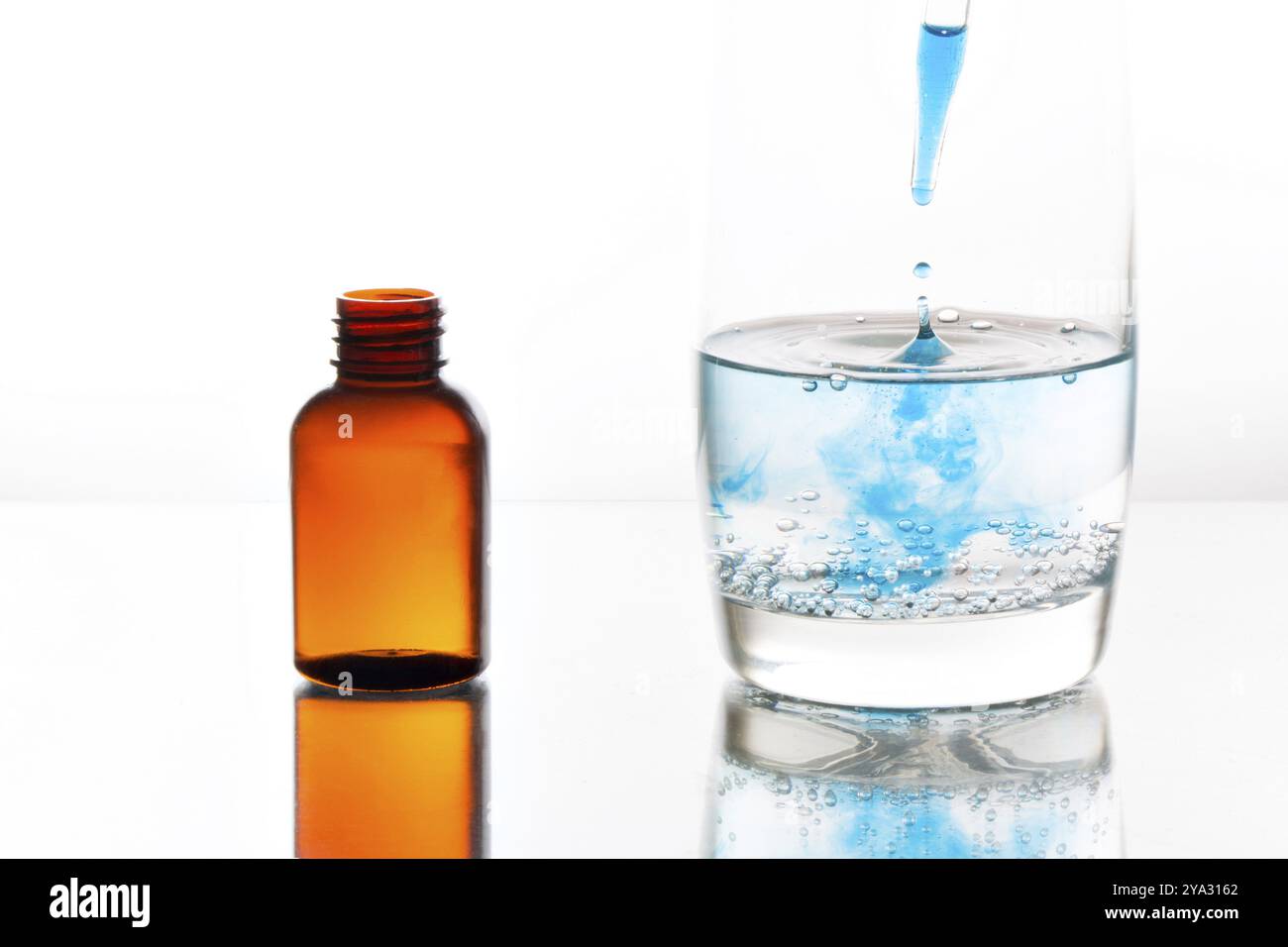 Drops of medication into a glass of water using a pipette Stock Photo ...