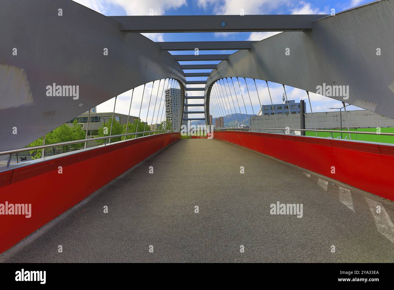 Steel bridge with urban background and cloudy sky, pedestrian bridge ...