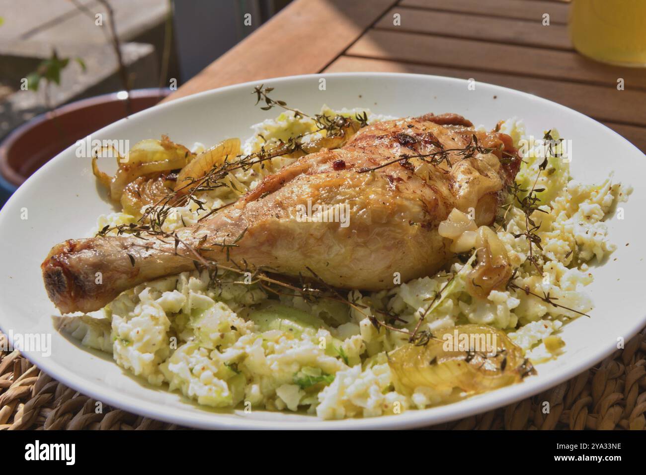 Cauliflower salad, crispy chicken legs, thyme and onions Stock Photo ...