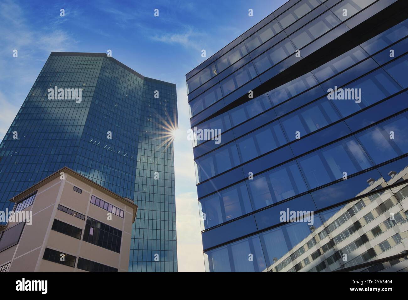 Modern high-rise building with glass facade and sunlight in an urban ...