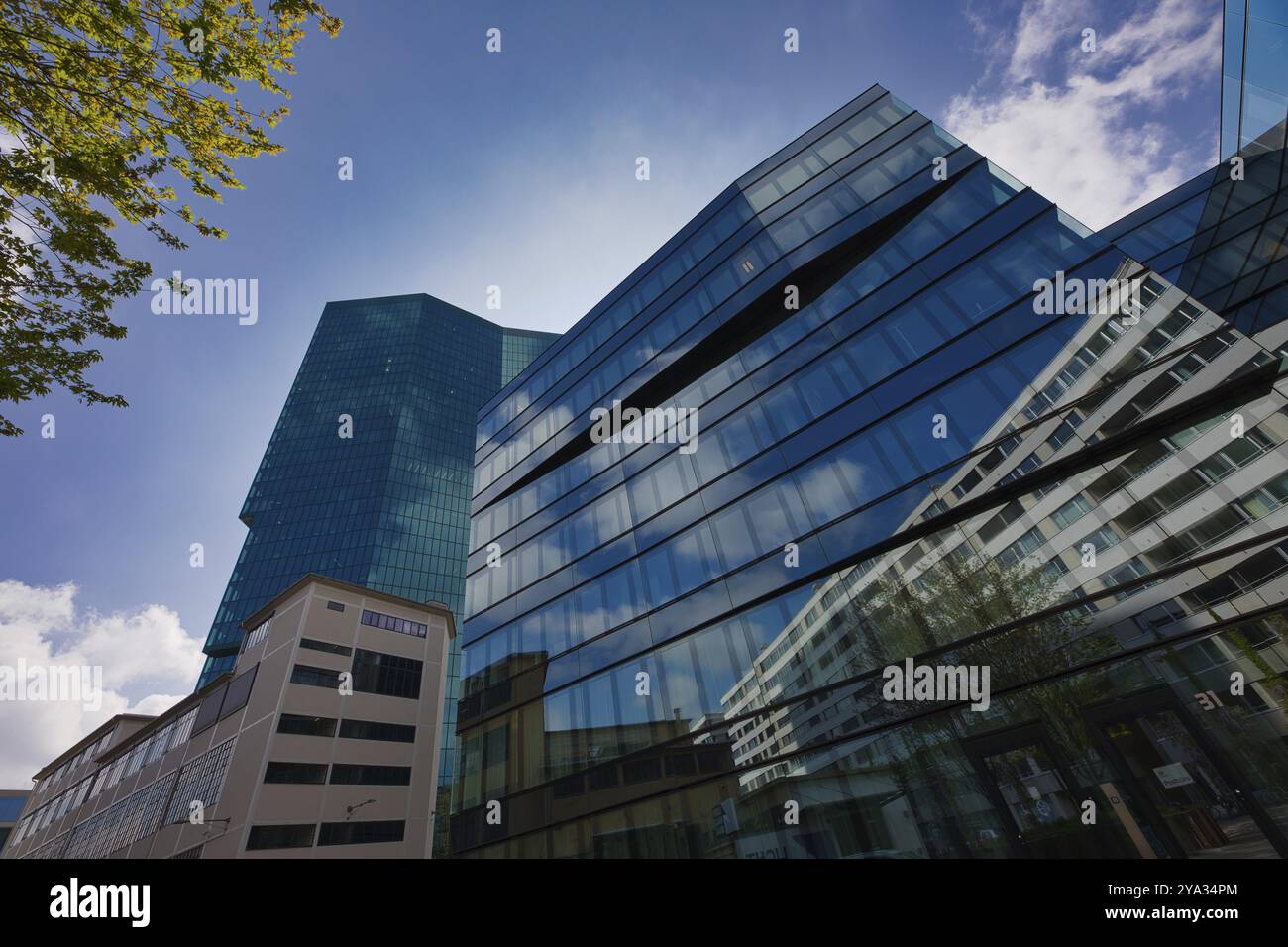 Interlocking modern buildings in Zurich are reflected in the light ...