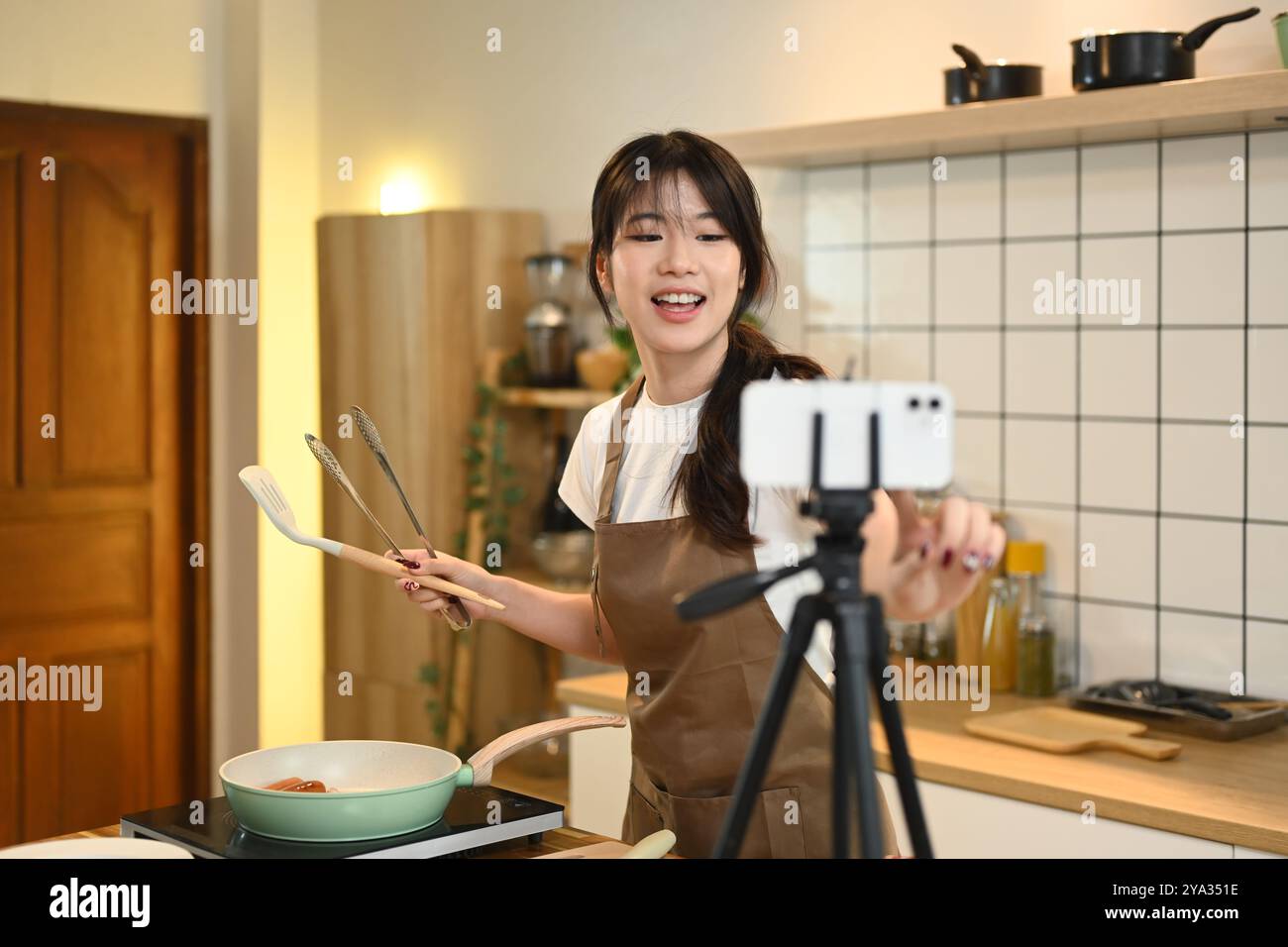 Young woman recording cooking tutorial hi-res stock photography and ...