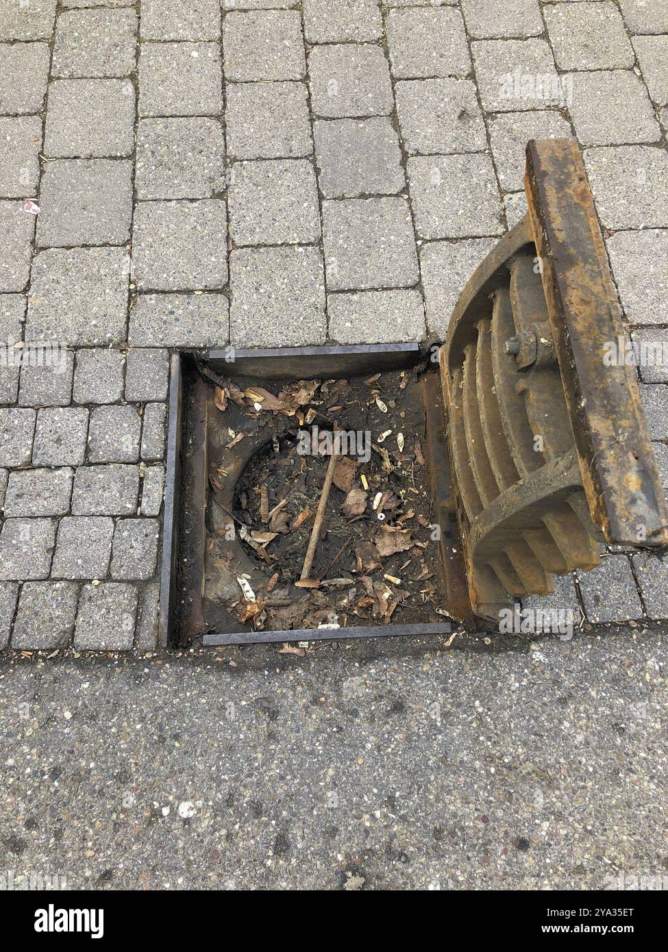 Inlet shaft for road drainage blocked by soil Stock Photo - Alamy