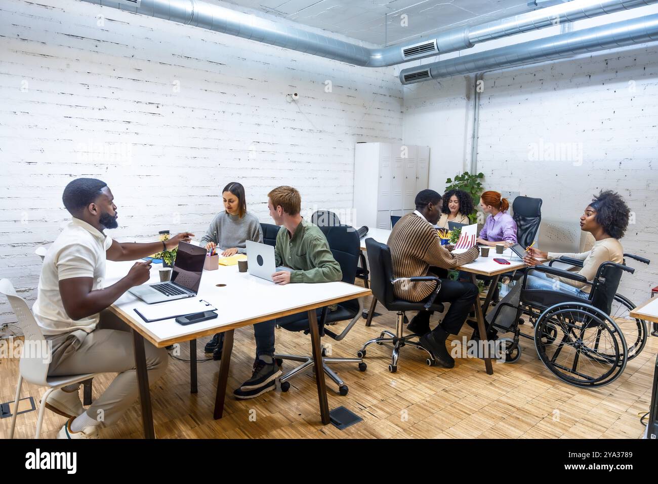 Diverse and multi-ethnic group of people working together in a modern ...