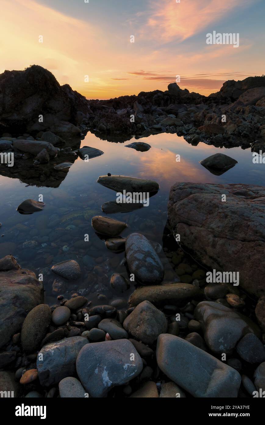 This is a color landscape photo of a vivid sunset over the Pacific ...