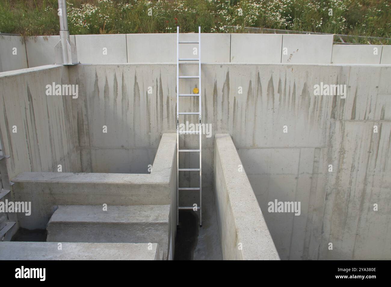Ladder is standing in a sewer in a sewage treatment plant without ...