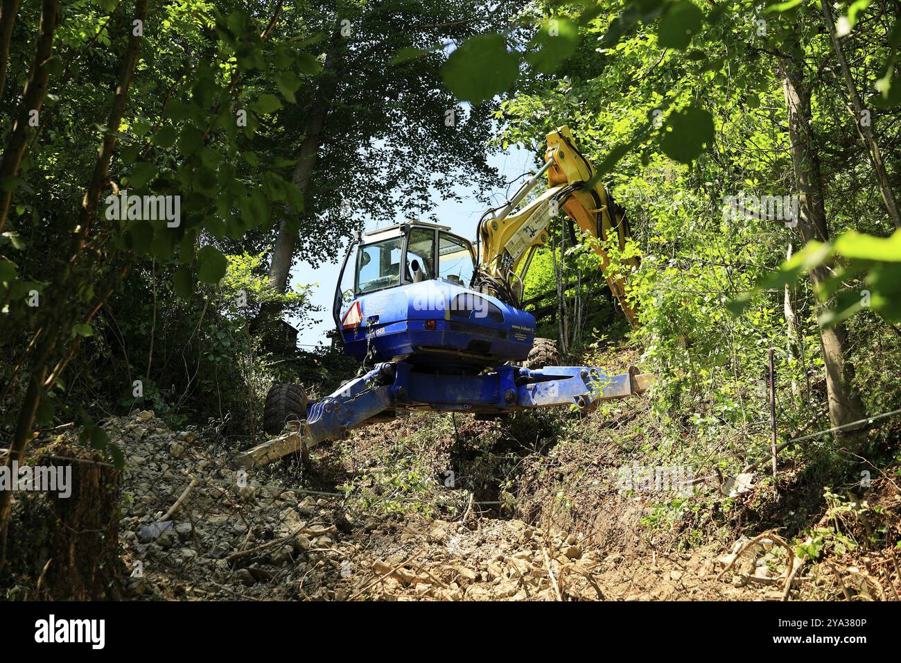 Excavator on a steep slope Stock Photo - Alamy