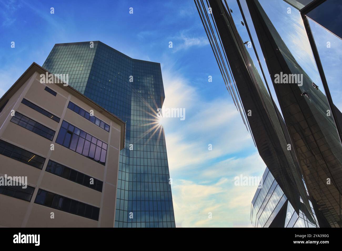 Modern building with glass facade and sunbeams in the clear sky, Prime Tower, Zurich, glass ...