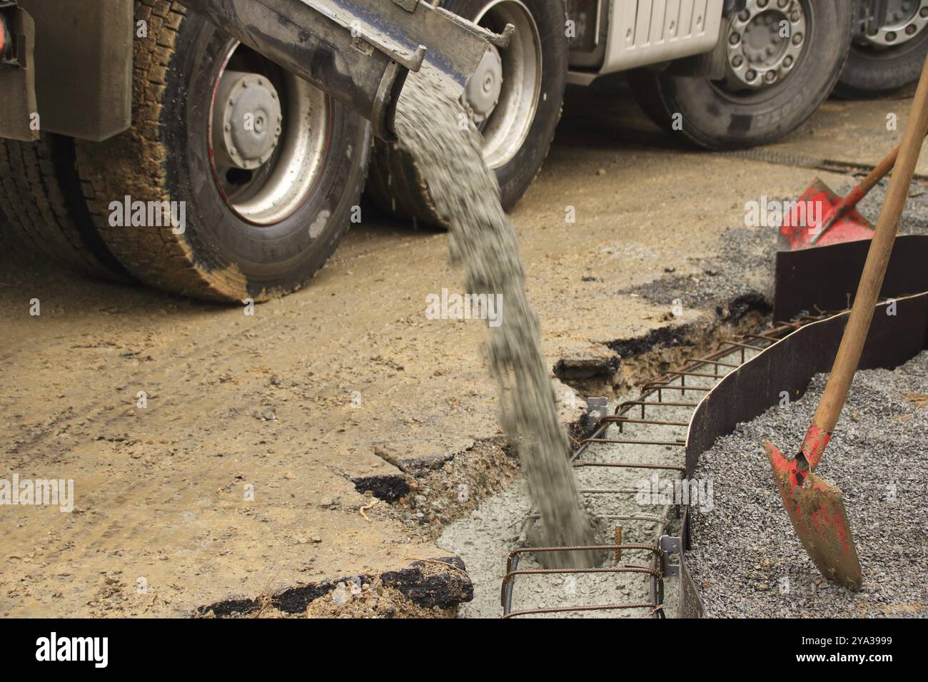Filling a strip foundation with liquid concrete Stock Photo - Alamy