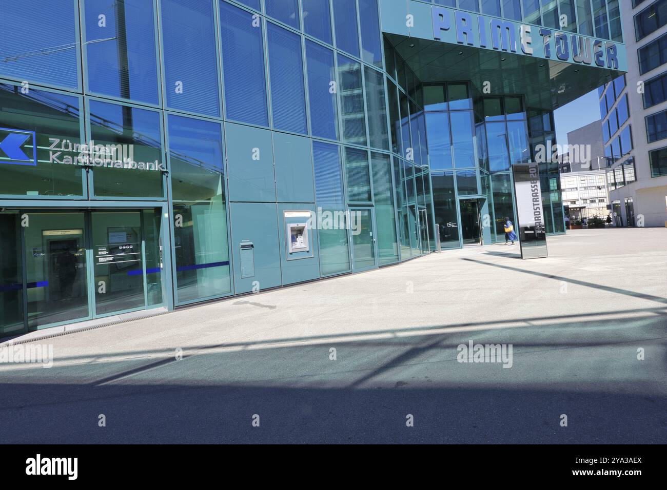 The modern glass facade of the Prime Tower reflects the sunlight and ...