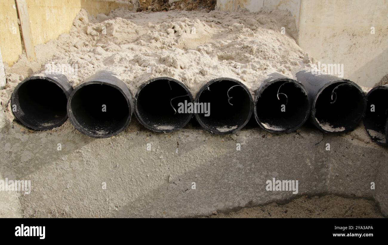 Empty conduits for electricity and water pipes on a construction site ...