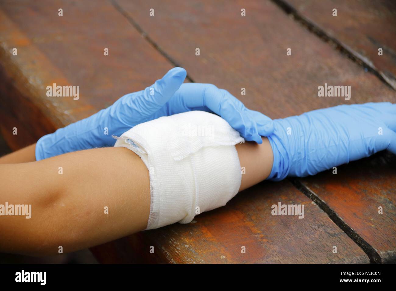 Applying a pressure bandage to a wound on a forearm Stock Photo - Alamy