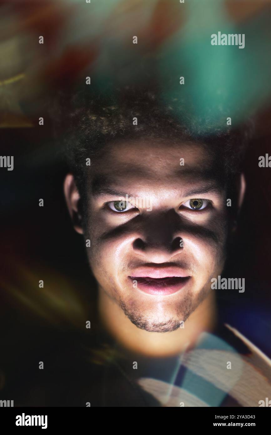 headshot of scarry young man with sinister smile and curly hair ...