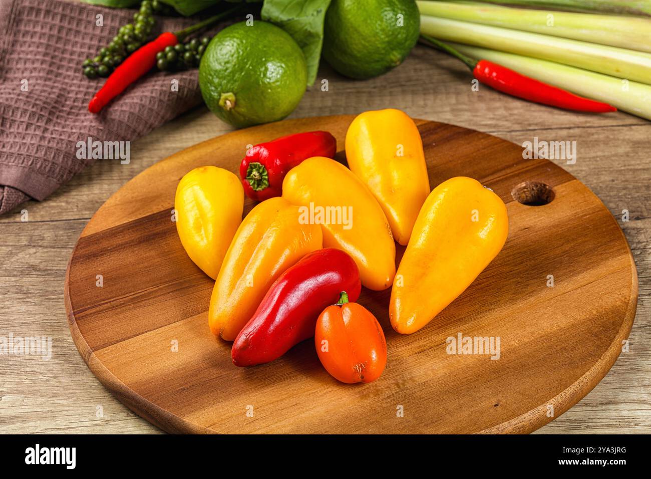Small baby red and yellow bell pepper heap Stock Photo - Alamy