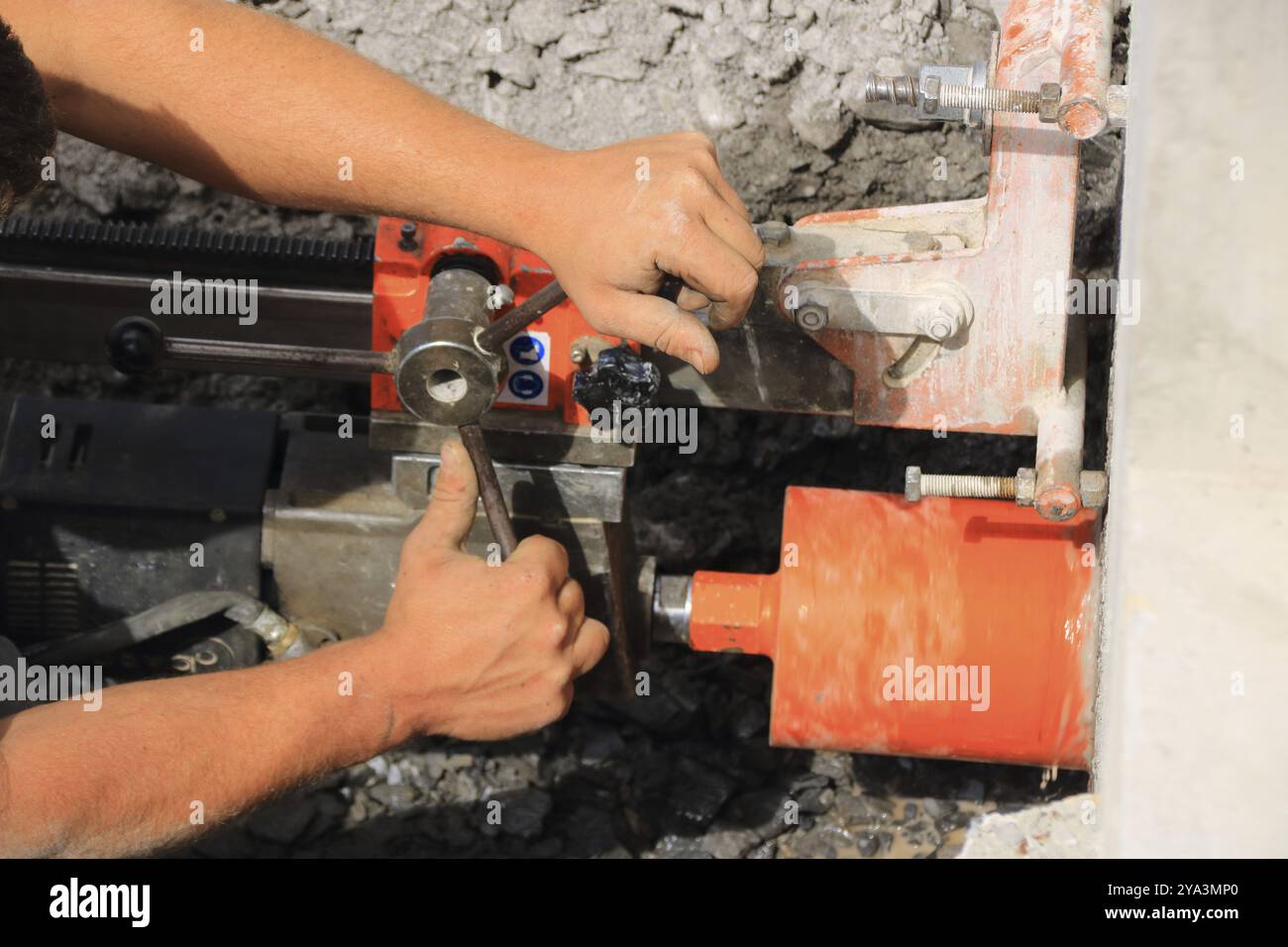 Worker drills a core hole in a house wall Stock Photo - Alamy