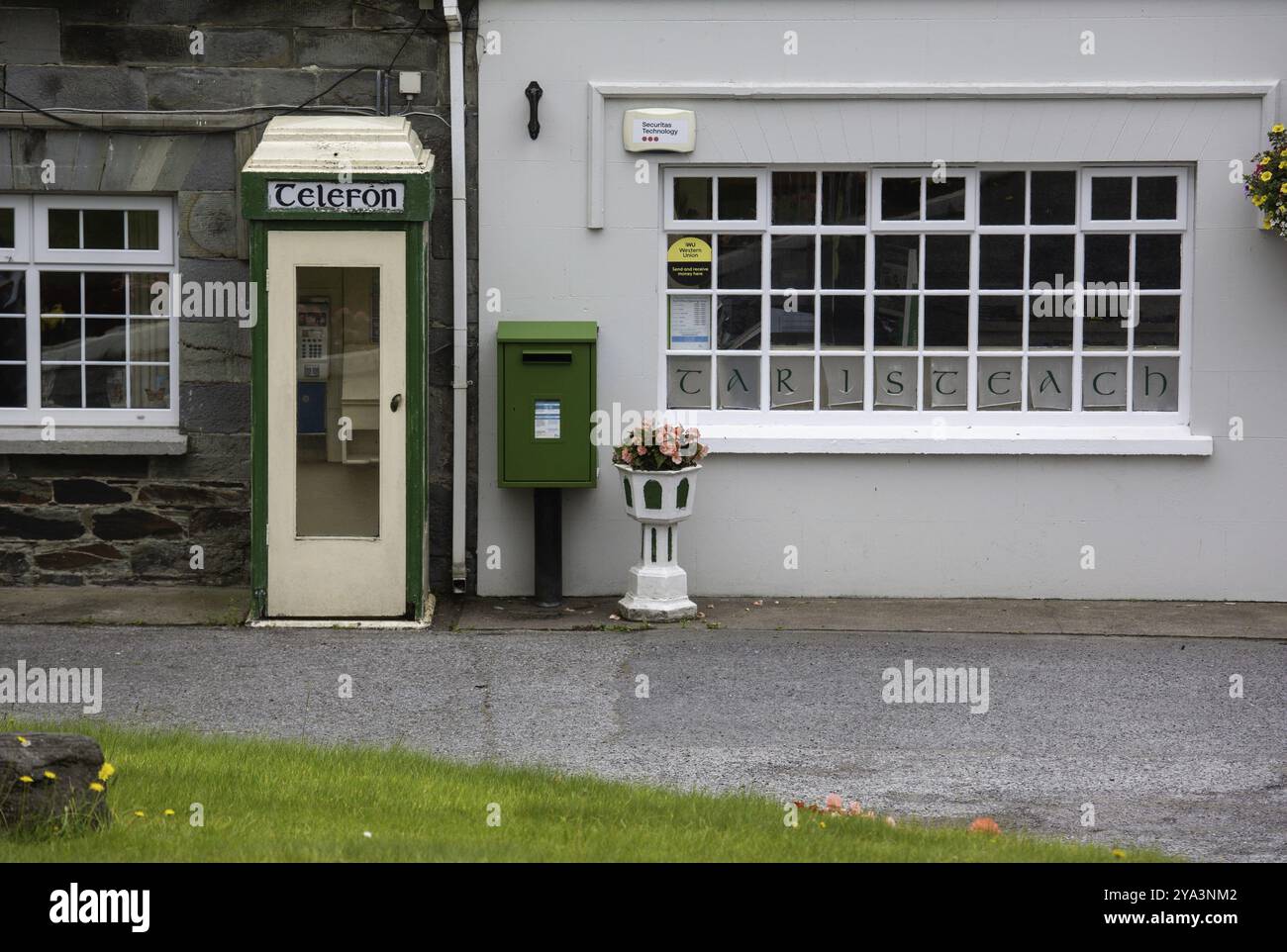 A traditional Irish phone booth and post office with the Gaelic words ...