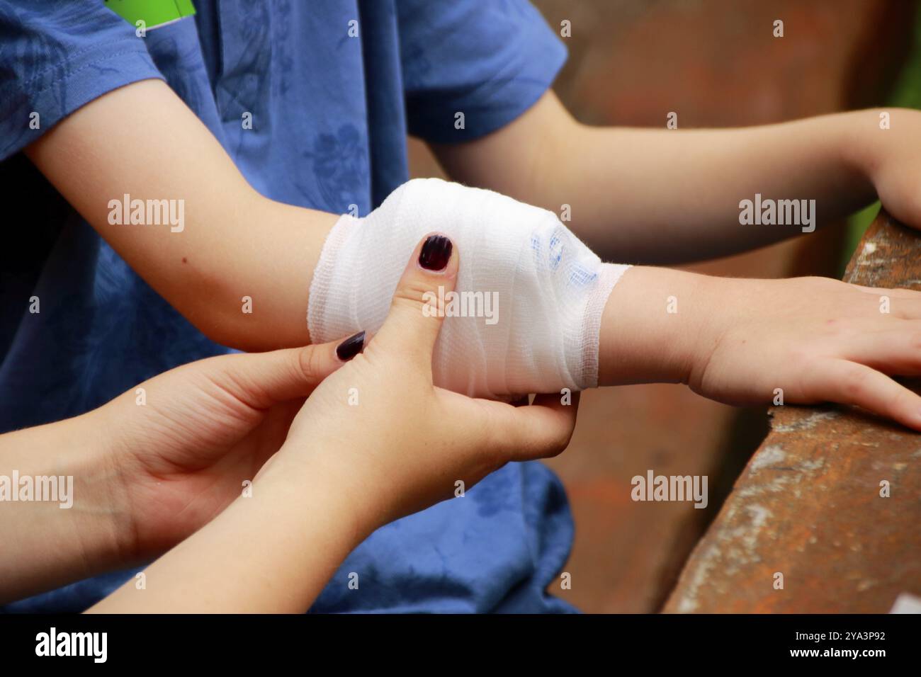Applying a pressure bandage to a wound on a forearm Stock Photo - Alamy