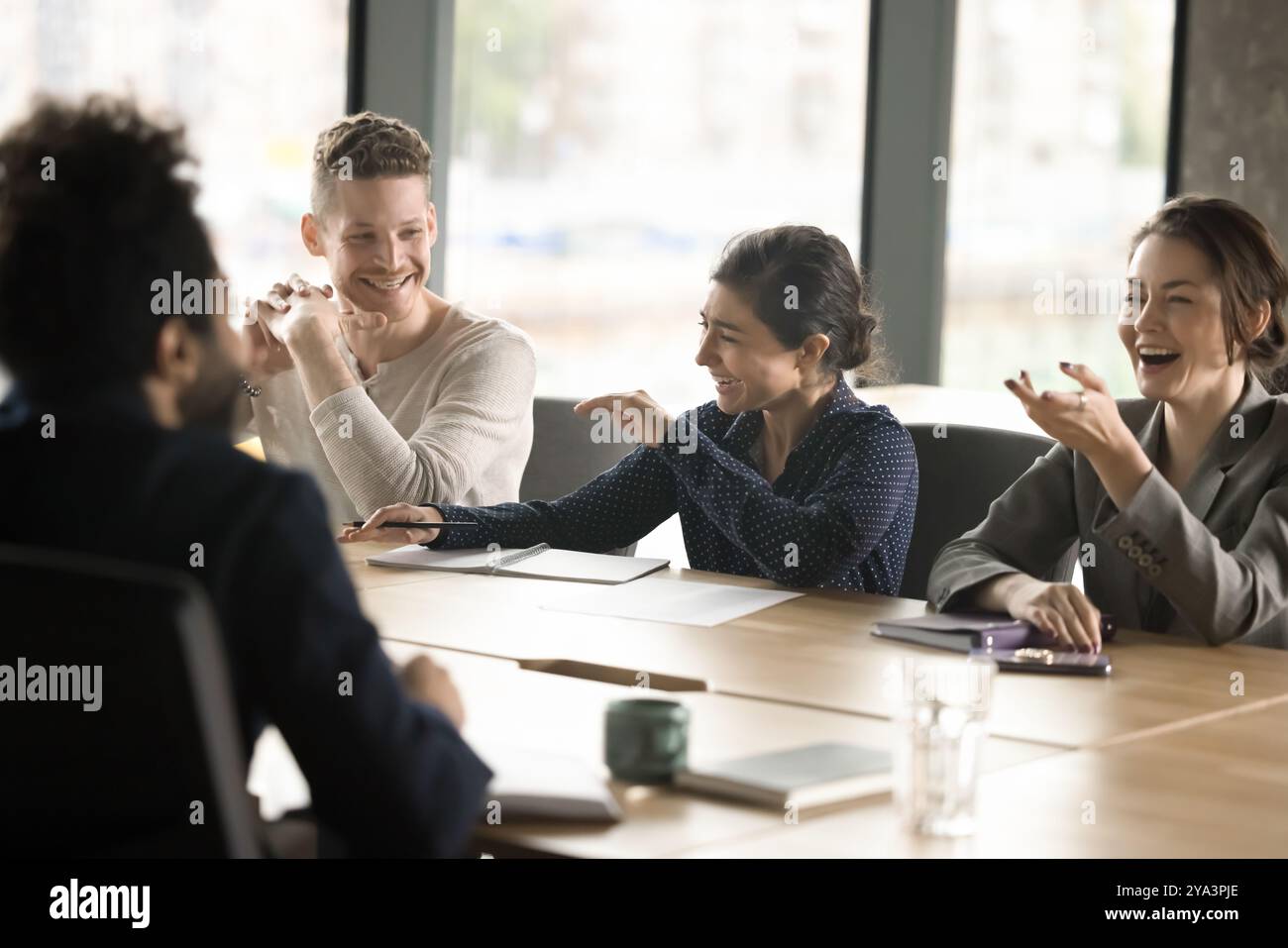 Cheerful multiethnic managers staff laughing at meeting table Stock ...