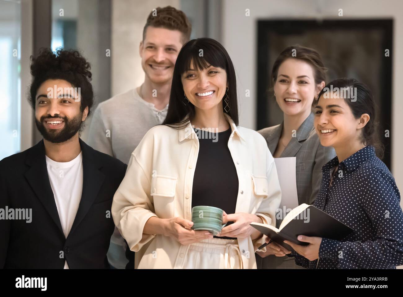 Happy diverse office team with female Latin leader standing together ...
