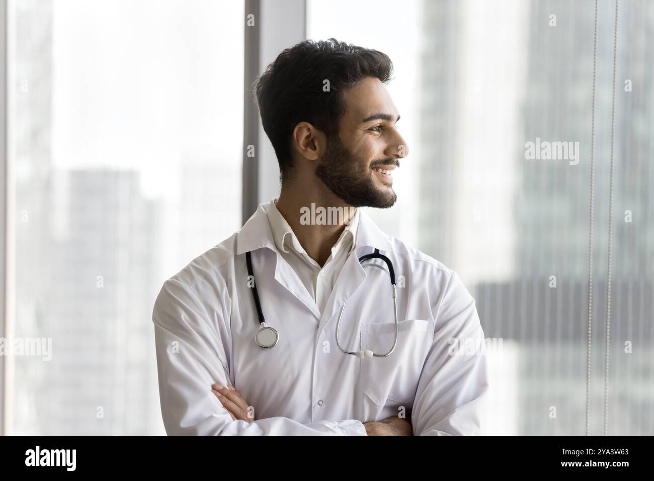 Happy ambitious doctor stand in confident pose look at window Stock ...