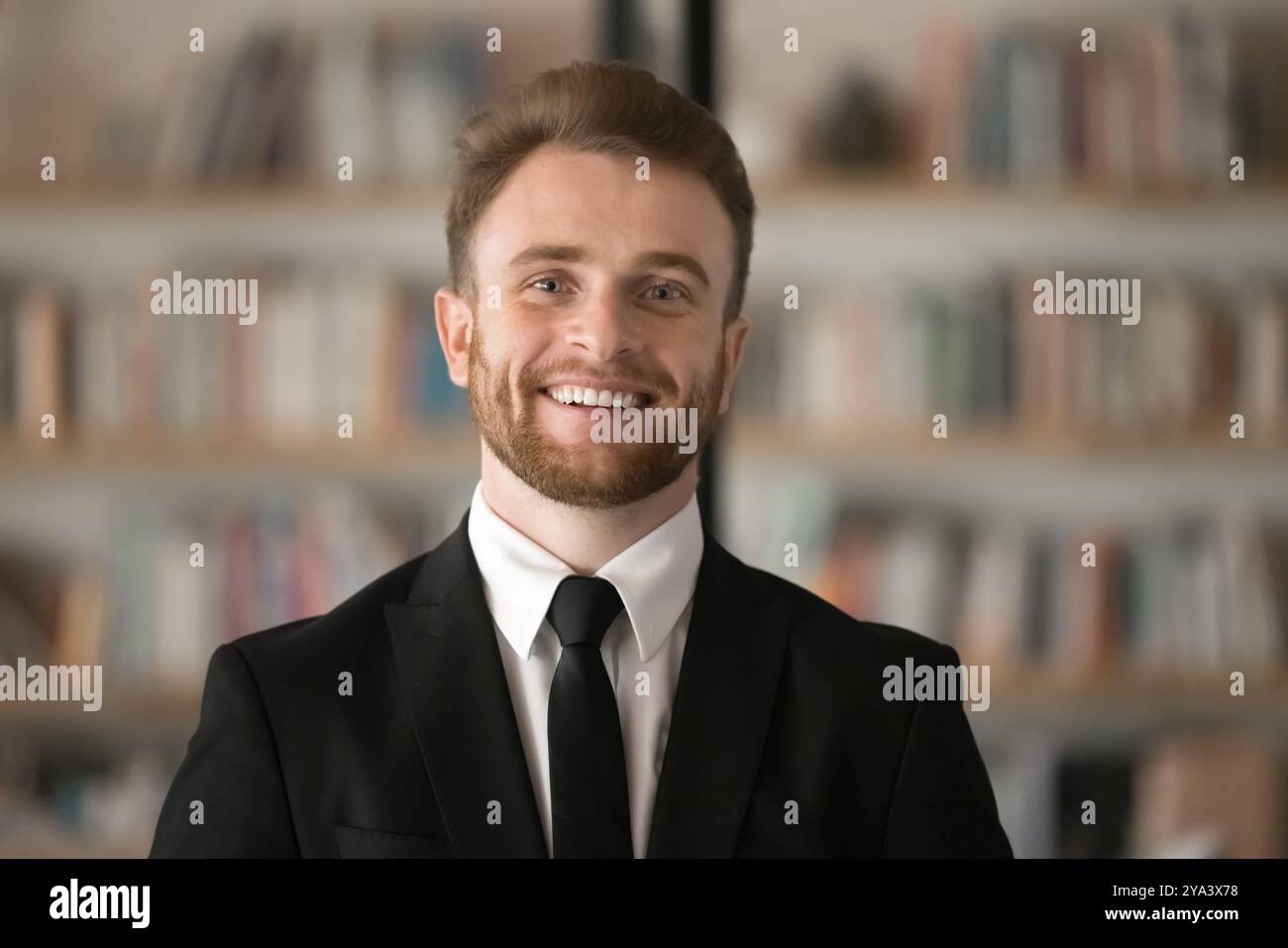 Happy handsome young Caucasian businessman looking at camera, smiling ...