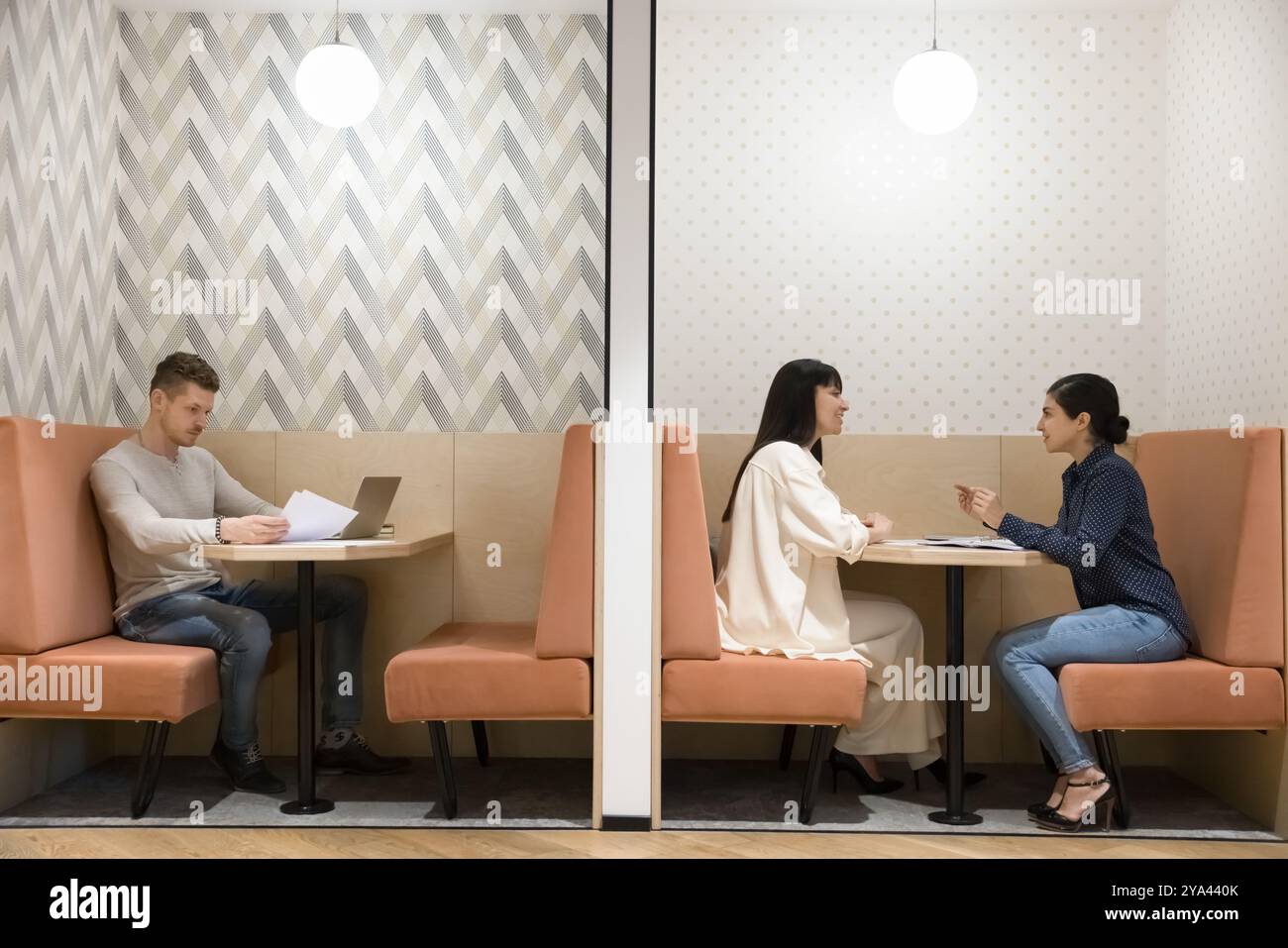 Multiethnic office employees working in modern co-working booths Stock ...