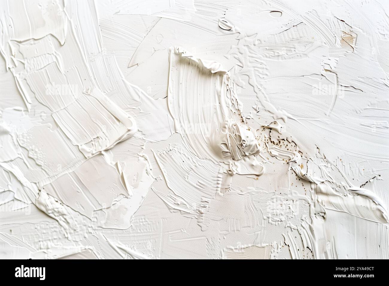 A white wall with white paint splatters and streaks. The wall appears ...