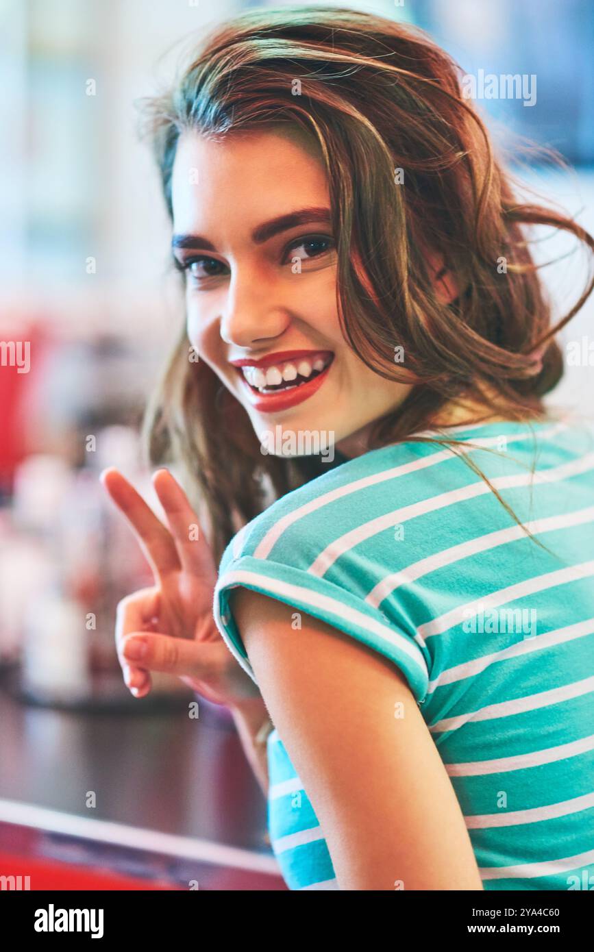 Peace sign, portrait and retro with woman in diner to relax for ...