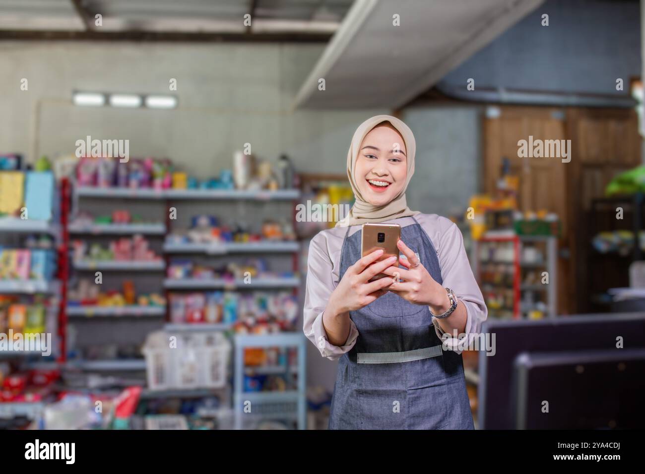 A friendly shopkeeper in a convenience store engaging positively with ...