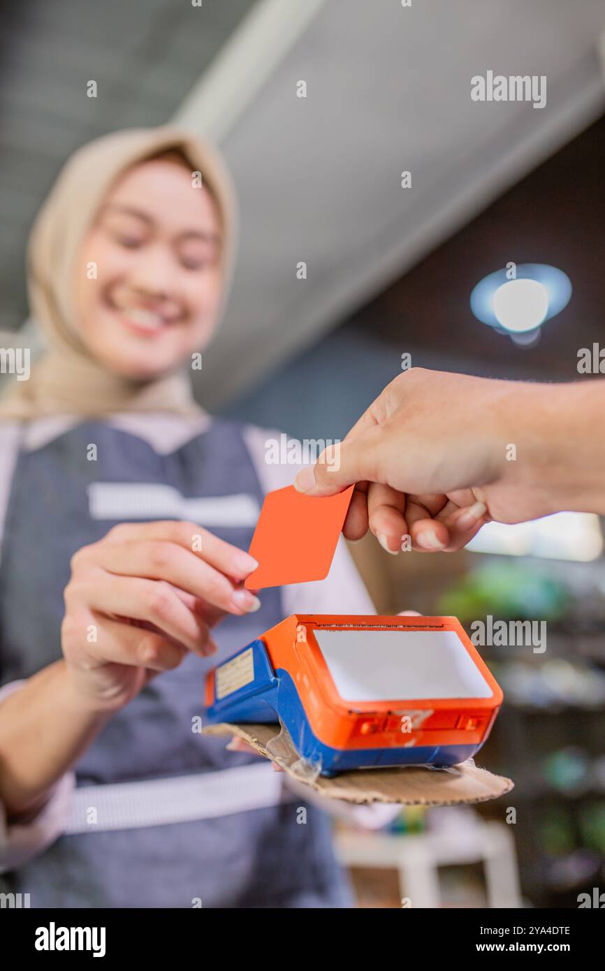 A customer is making a contactless payment at a retail store checkout ...