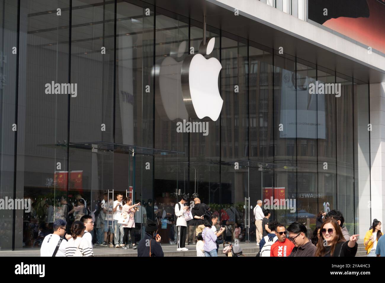 SHANGHAI, CHINA - OCTOBER 12, 2024 - Visitors pass the Apple Store on ...