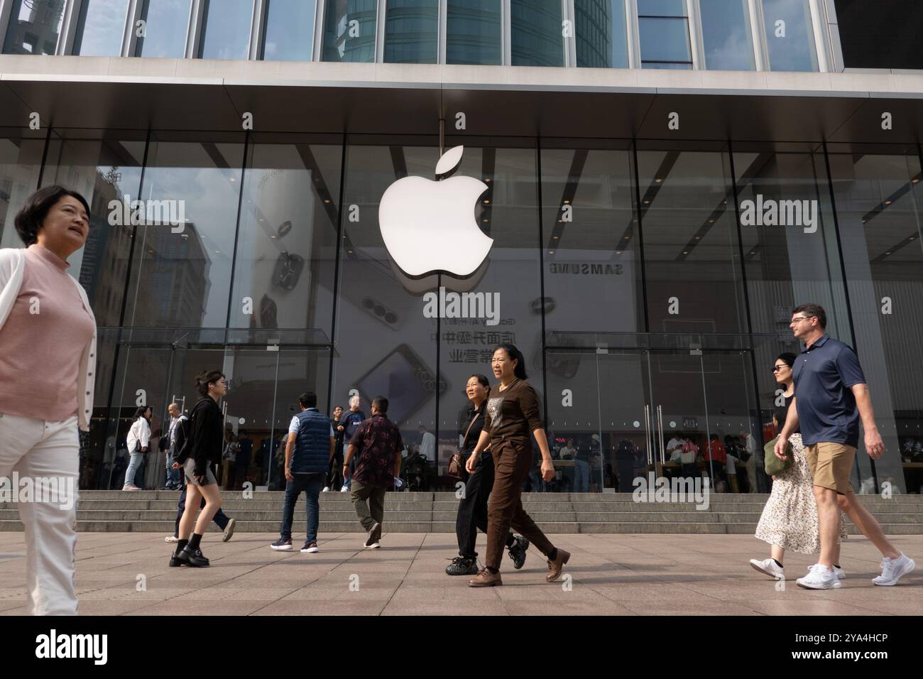 SHANGHAI, CHINA - OCTOBER 12, 2024 - Visitors pass the Apple Store on ...
