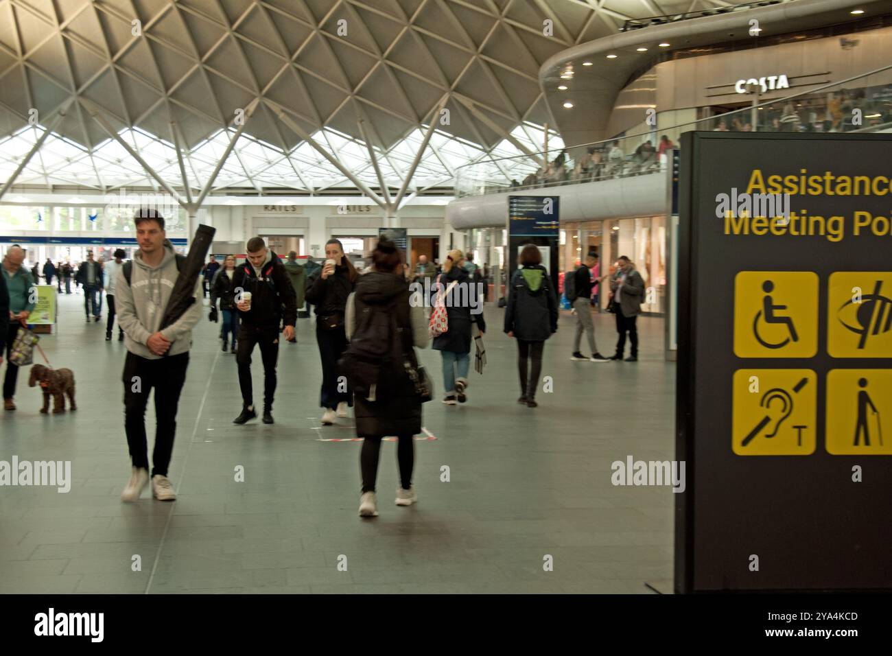 Concourse, Service area with people waiting to board their trains ...
