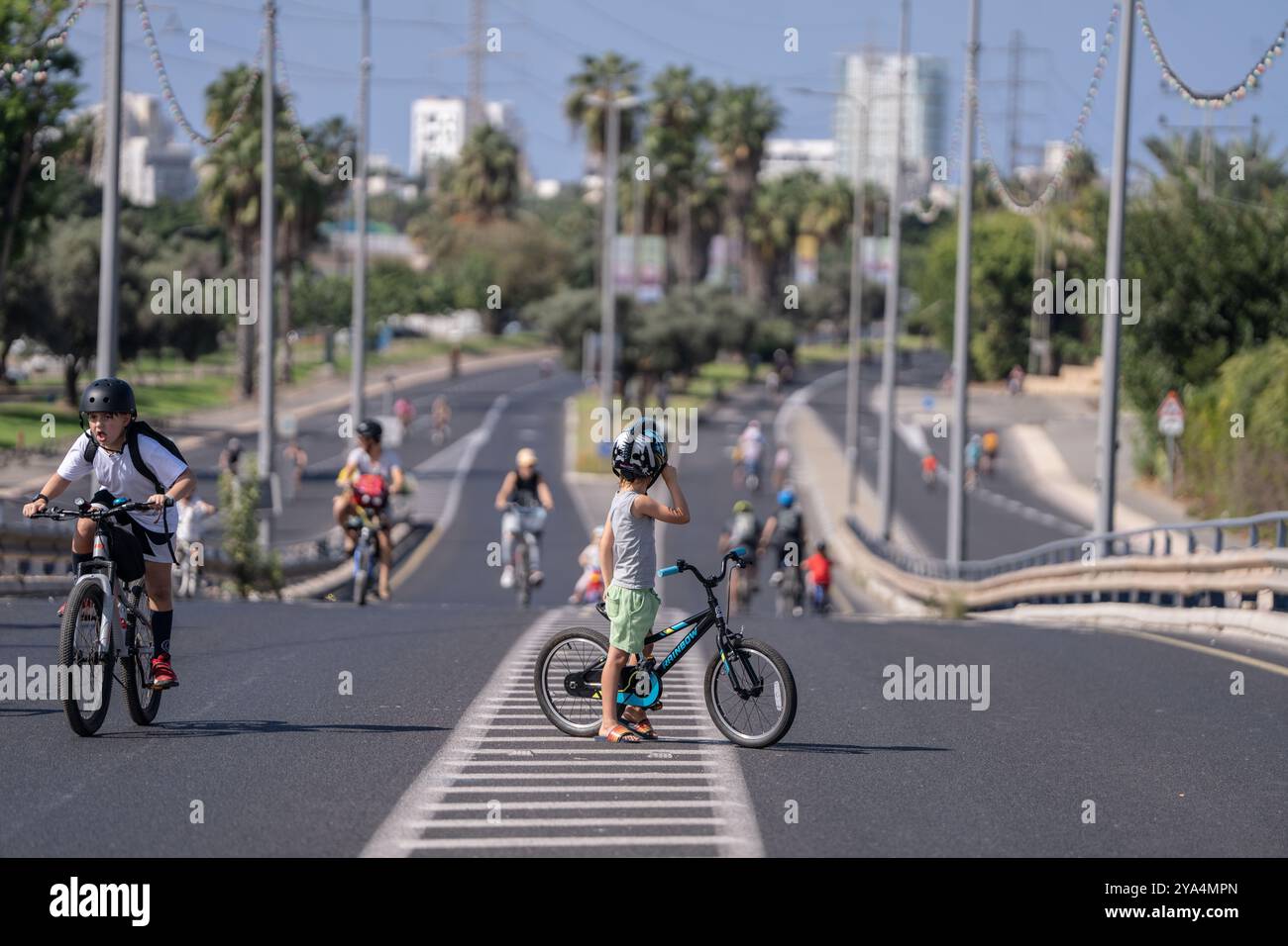 12 October 2024, Israel, Tel Aviv: People ride their bicycles along an ...