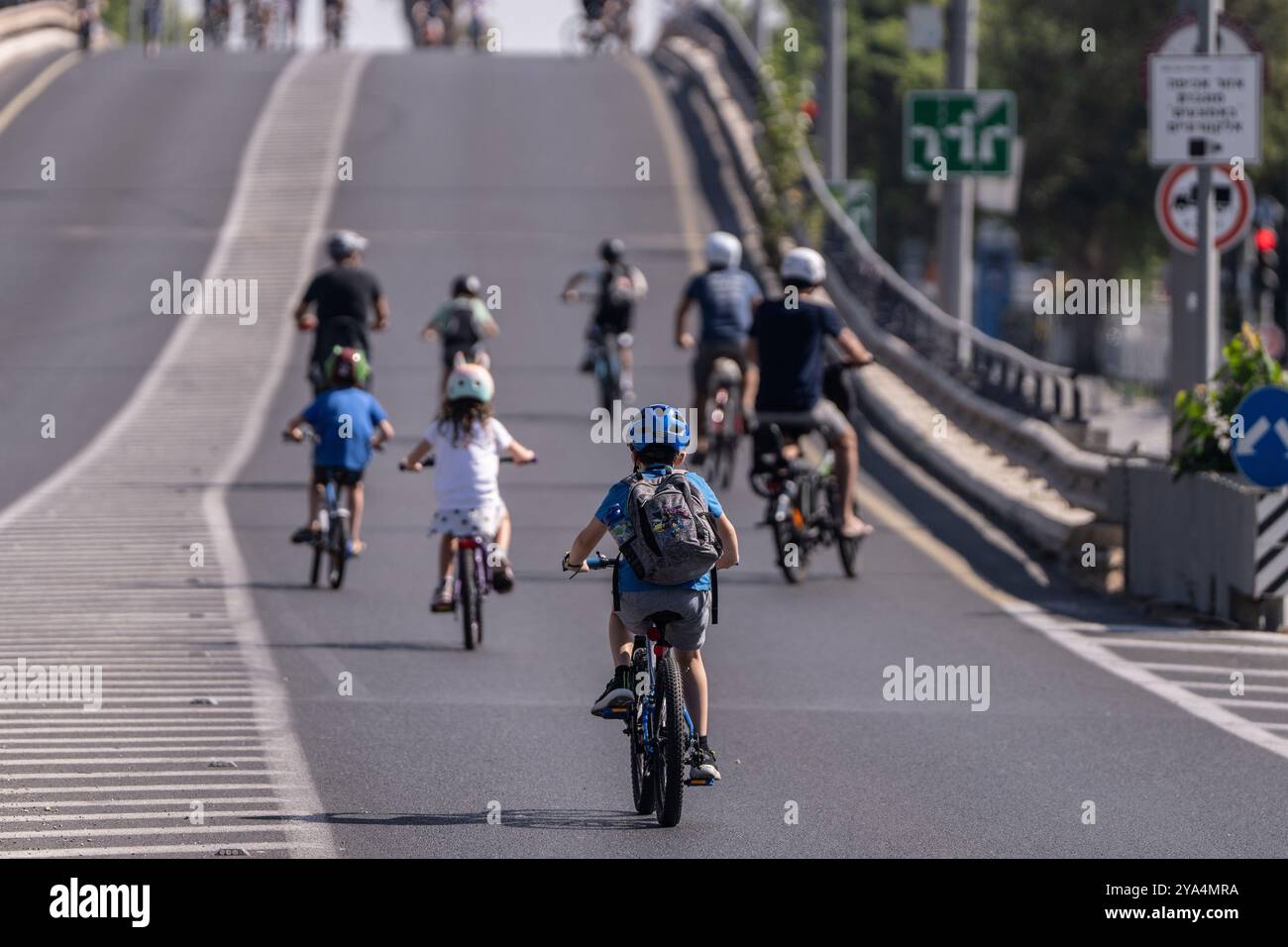 12 October 2024, Israel, Tel Aviv: People ride their bicycles along an ...