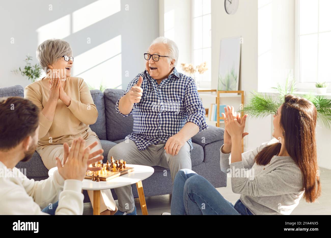 Smiles and laugh in living room family old parents daughter son enjoys ...