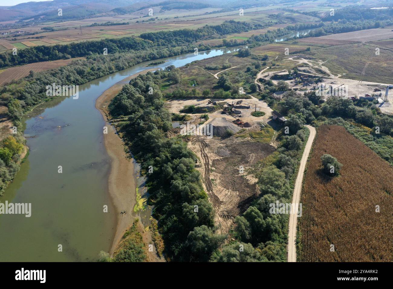 Aerial view of gravel pit mining reservoir and river, ballast ...