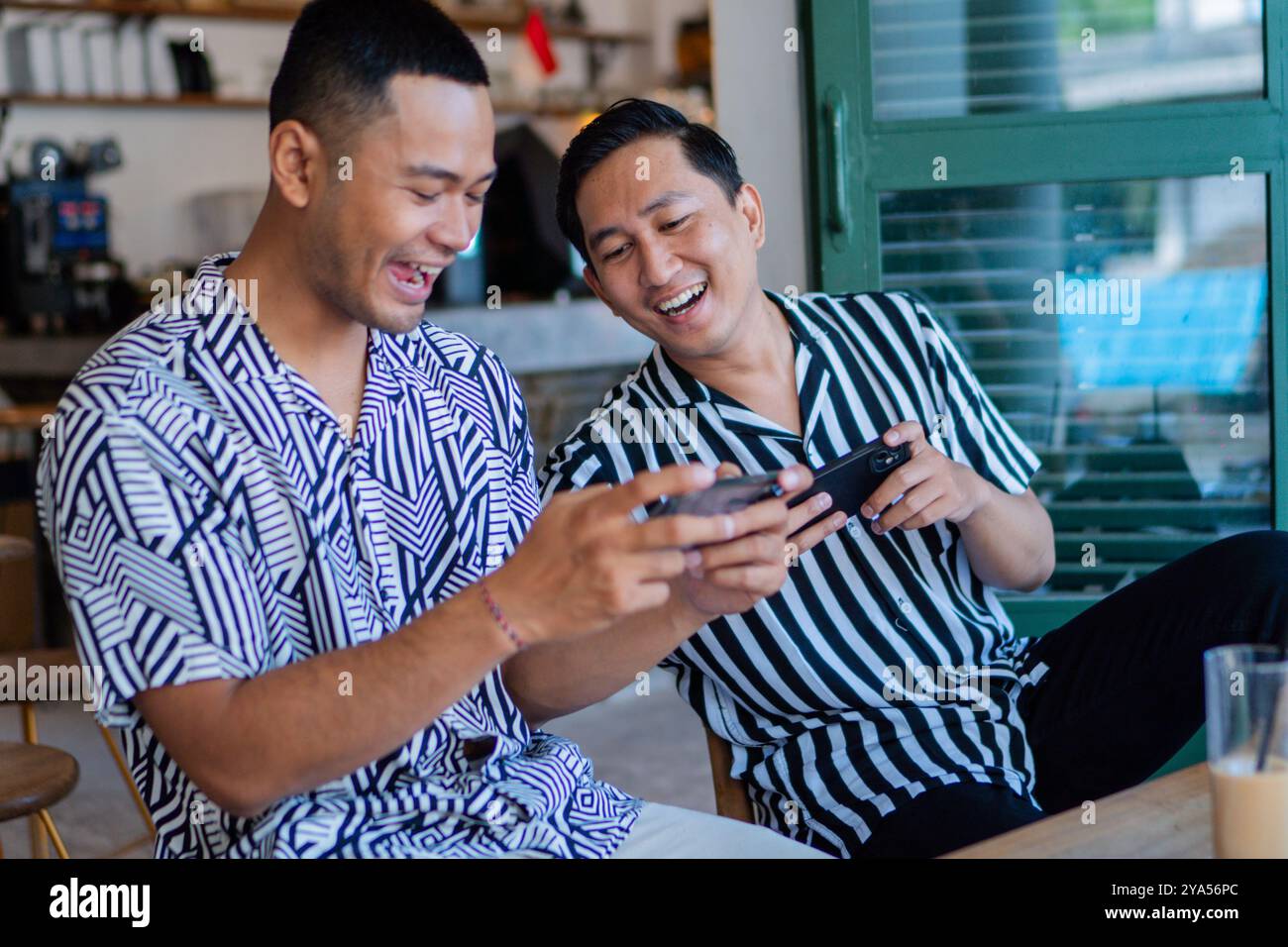 Two Friends are Having a Great Time Enjoying Gaming Together in a Cozy ...