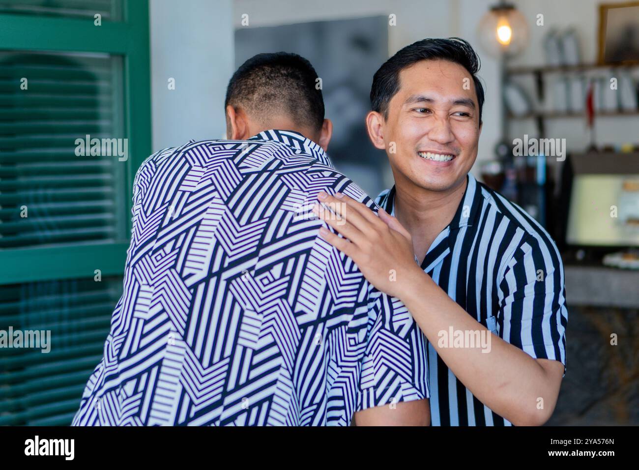 Warm embrace between friends hi-res stock photography and images - Alamy