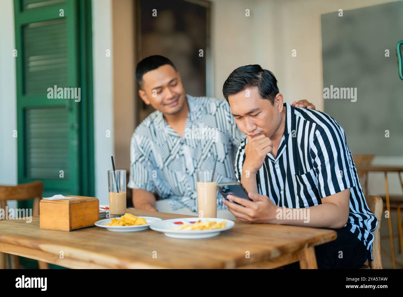 Two Close Friends Enjoying a Relaxing Moment Together with Snacks and ...