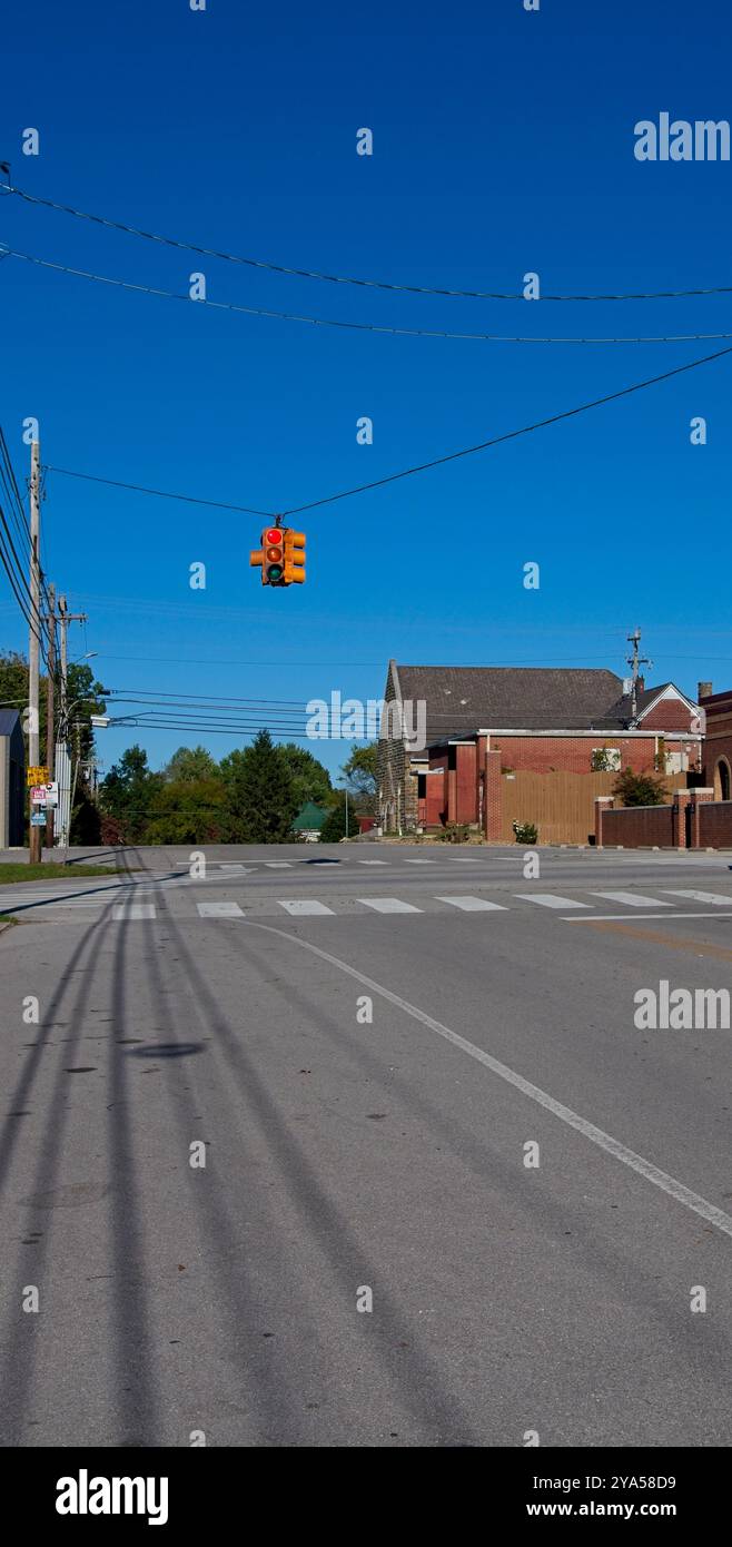 Empty intersection in a small town with traffic light on red Stock ...