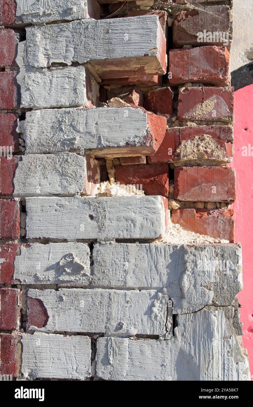 Column of bricks that are decaying and broken with stucco remnants ...