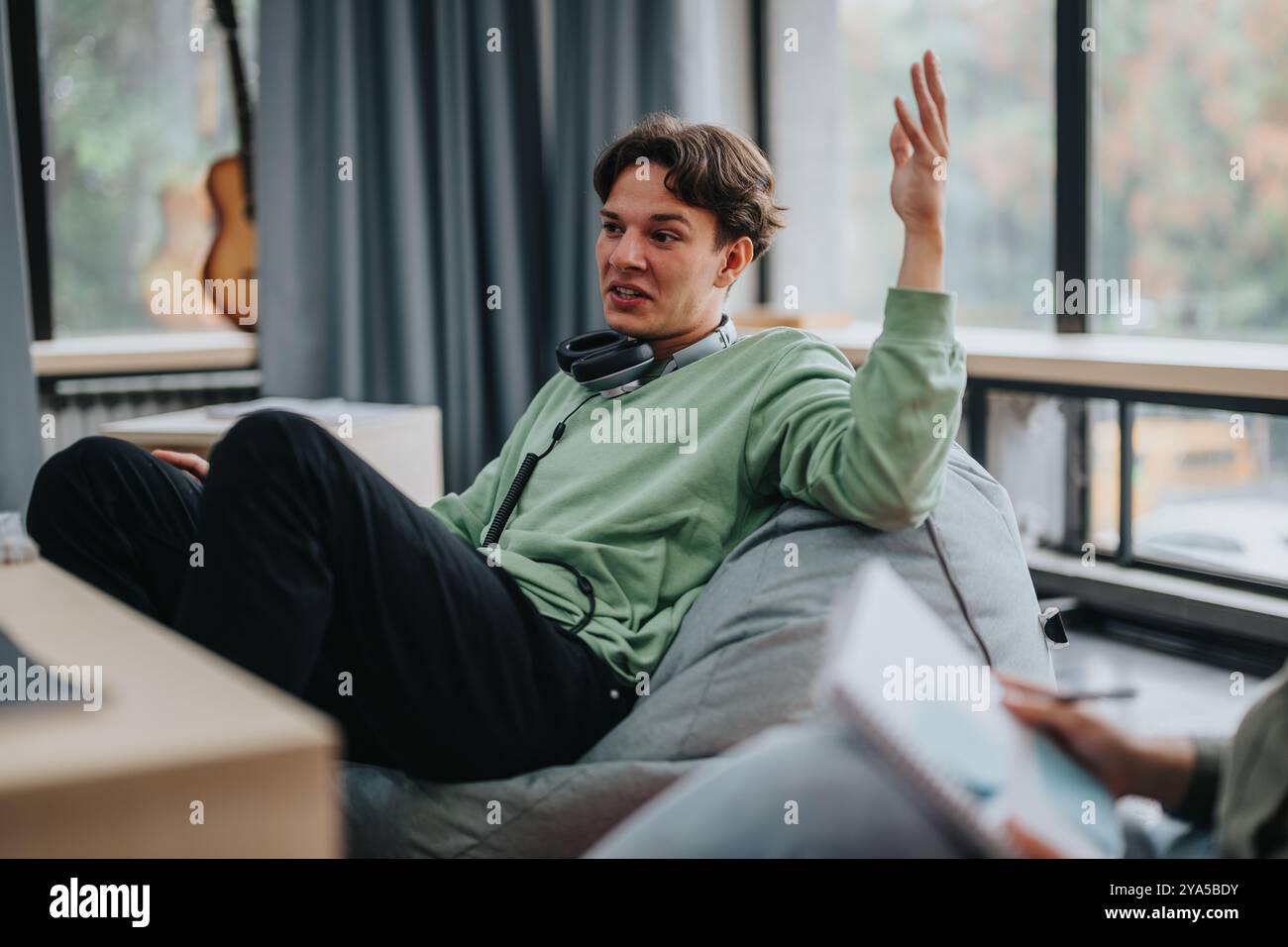 Professor discussing ideas with students in a cozy classroom setting ...