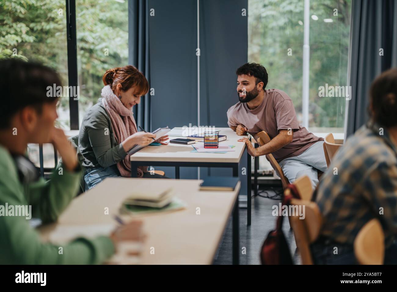 Students engaging with professor in a collaborative classroom setting ...